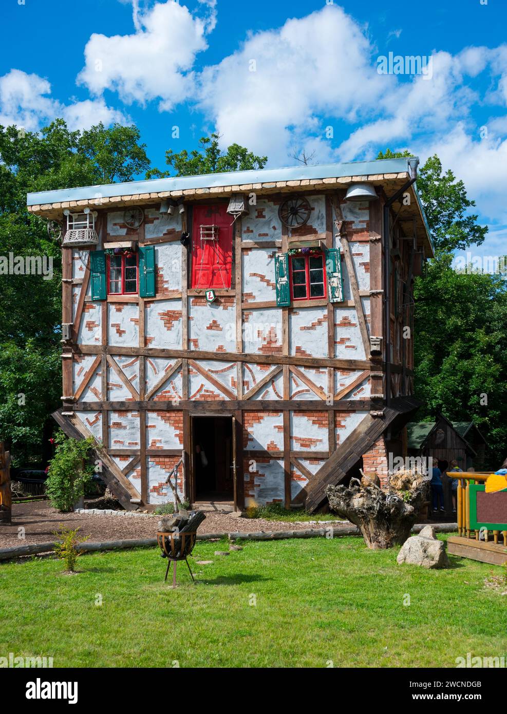 Traditional half-timbered house with bright red windows and red door ...