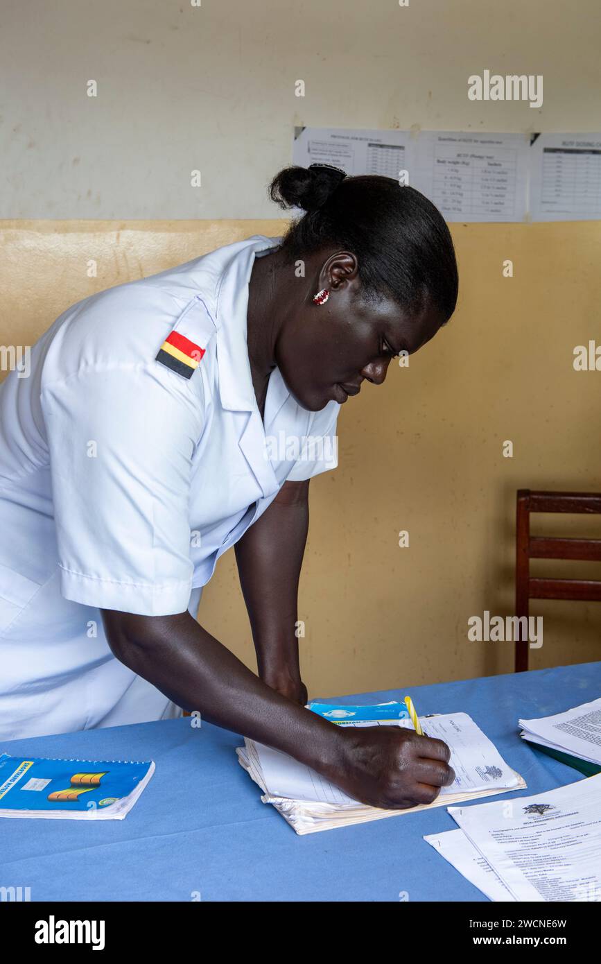 Uganda, Kitgum District. A nurse evaluates patients records at the ...