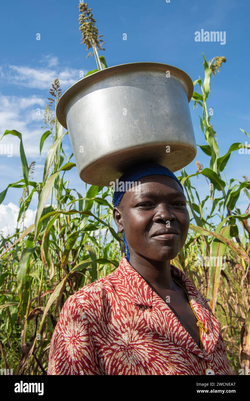 Uganda, Kitgum District. A mother carries a pot on her head. Editorial ...
