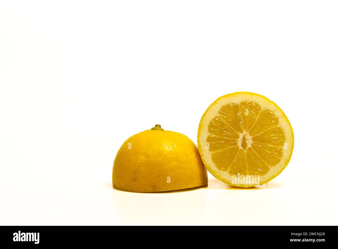 Close-up of a fresh lemon cut in half isolated on white background and ...