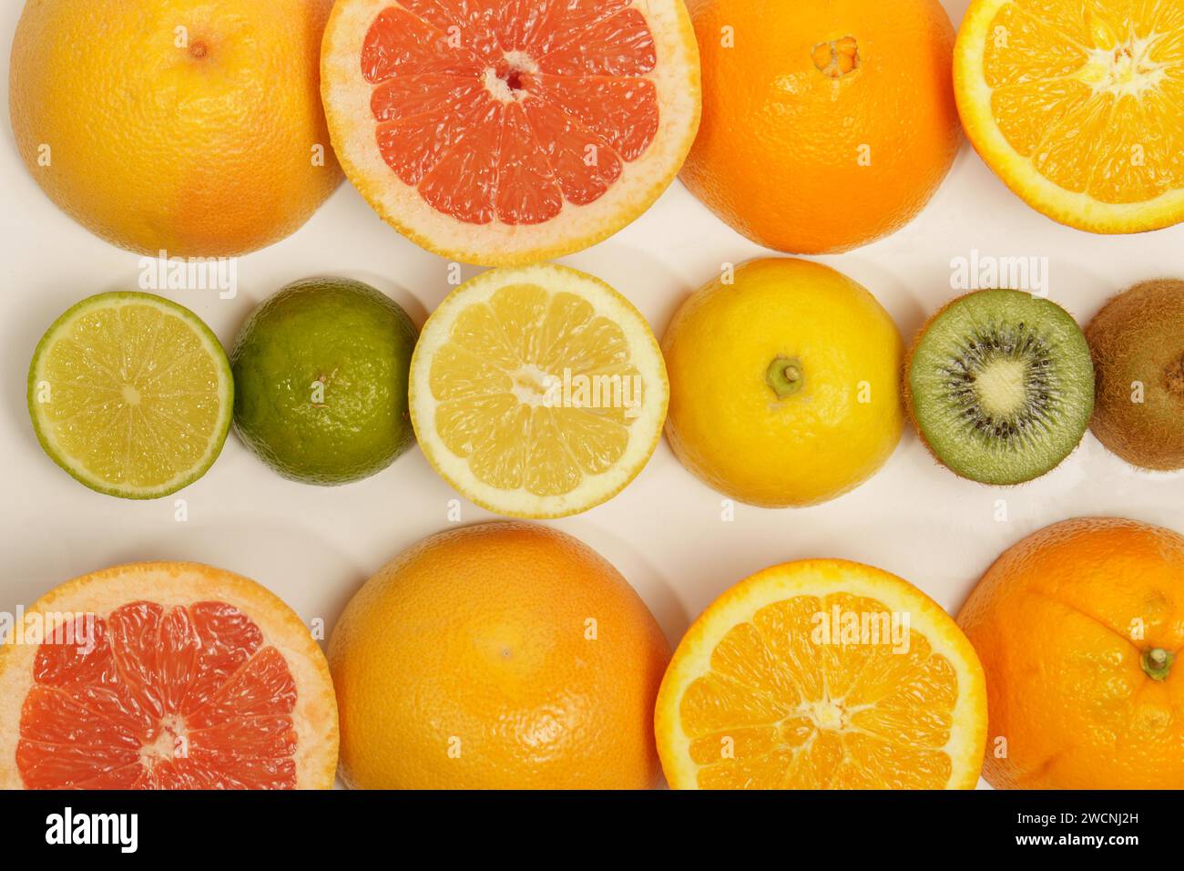 Photographic background of fruit cut in half with white background ...