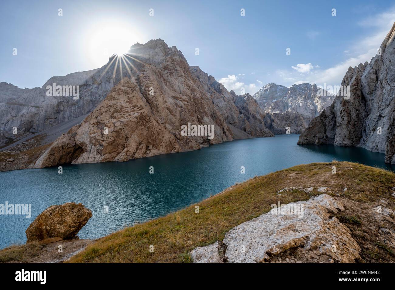 Mountain lake Kol Suu rocky steep mountains, sun star, Kol Suu Lake ...