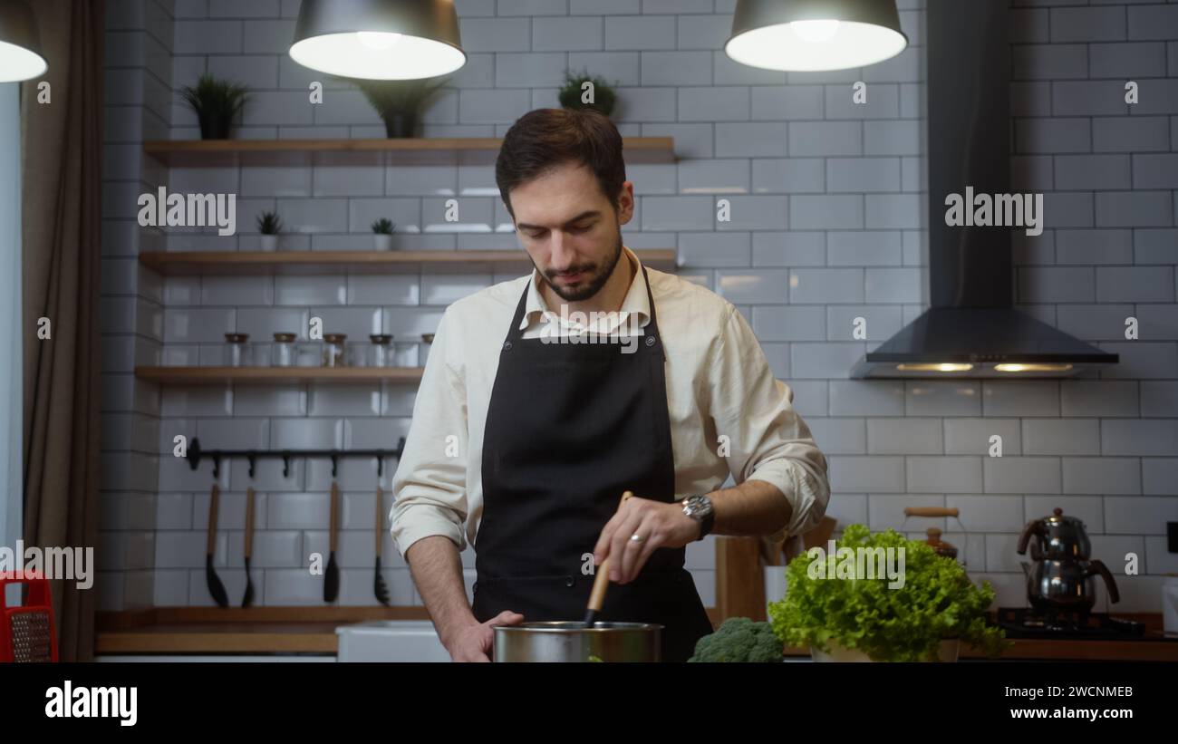 Handsome man cooks soup hi-res stock photography and images - Alamy