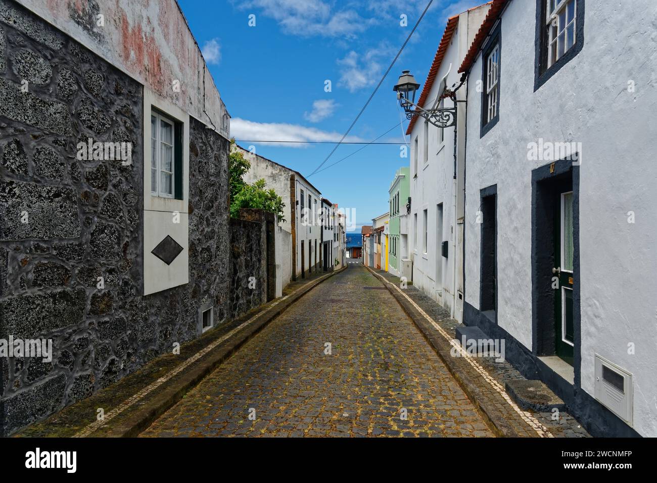 Empty cobbled street with traditional buildings of Lajes do Pico ...