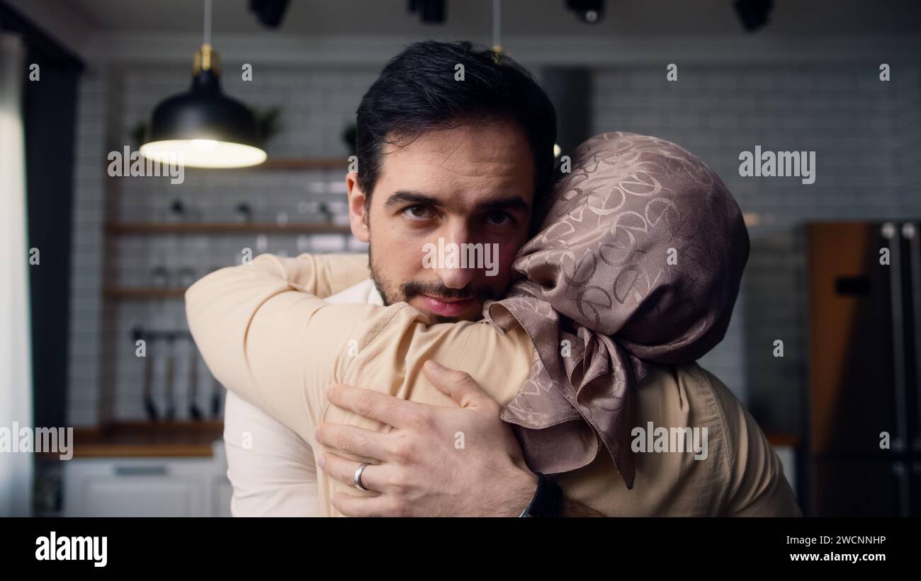 Rear view of woman hugging her husband. Romantic man hugging her wife ...