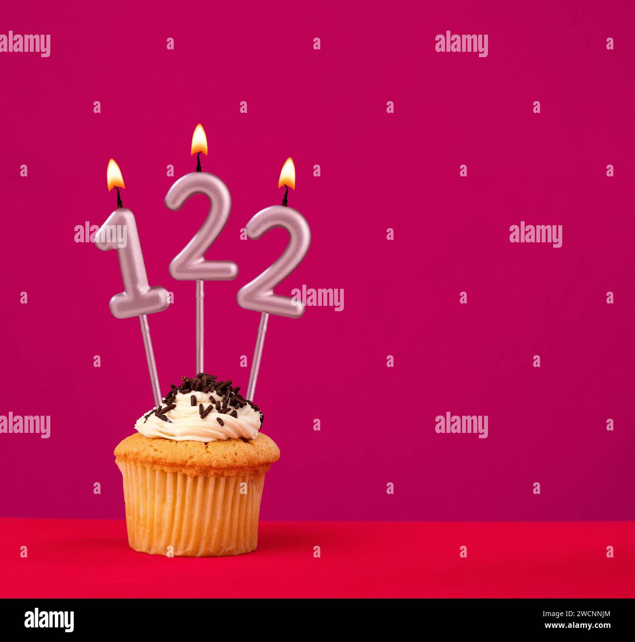 Candle number 122 - Cake birthday in rhodamine red background Stock ...