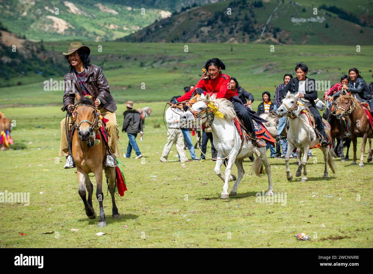 Tibet, Kham, Litang. Nomad men compete at a horse festival. Editorial ...