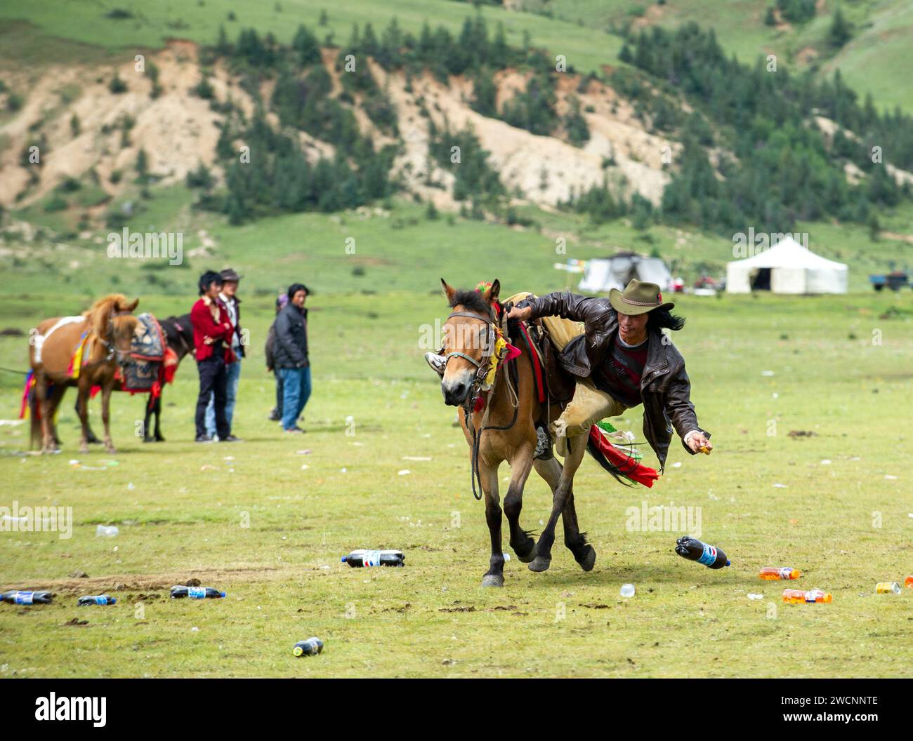 Tibet, Kham, Litang. Nomad men compete at a horse festival. Editorial ...