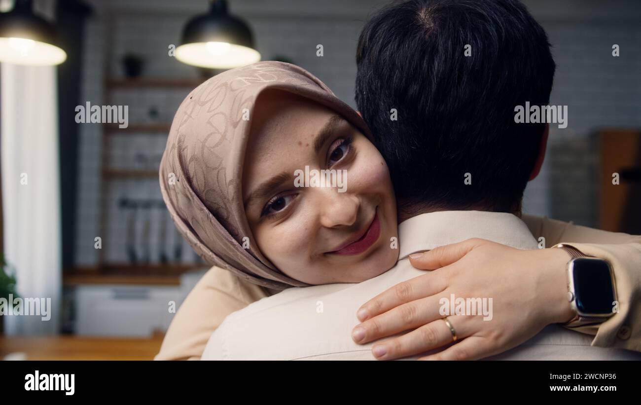 Rear view of man hugging her wife. Beautiful woman hugging her husband ...