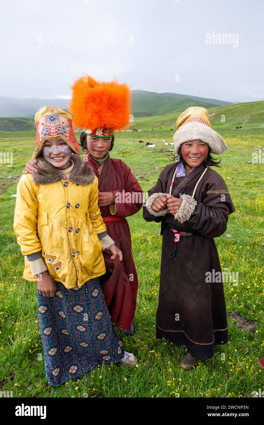 Tibet, Kham, Litang. Nomad children giggle while gathering plants on ...