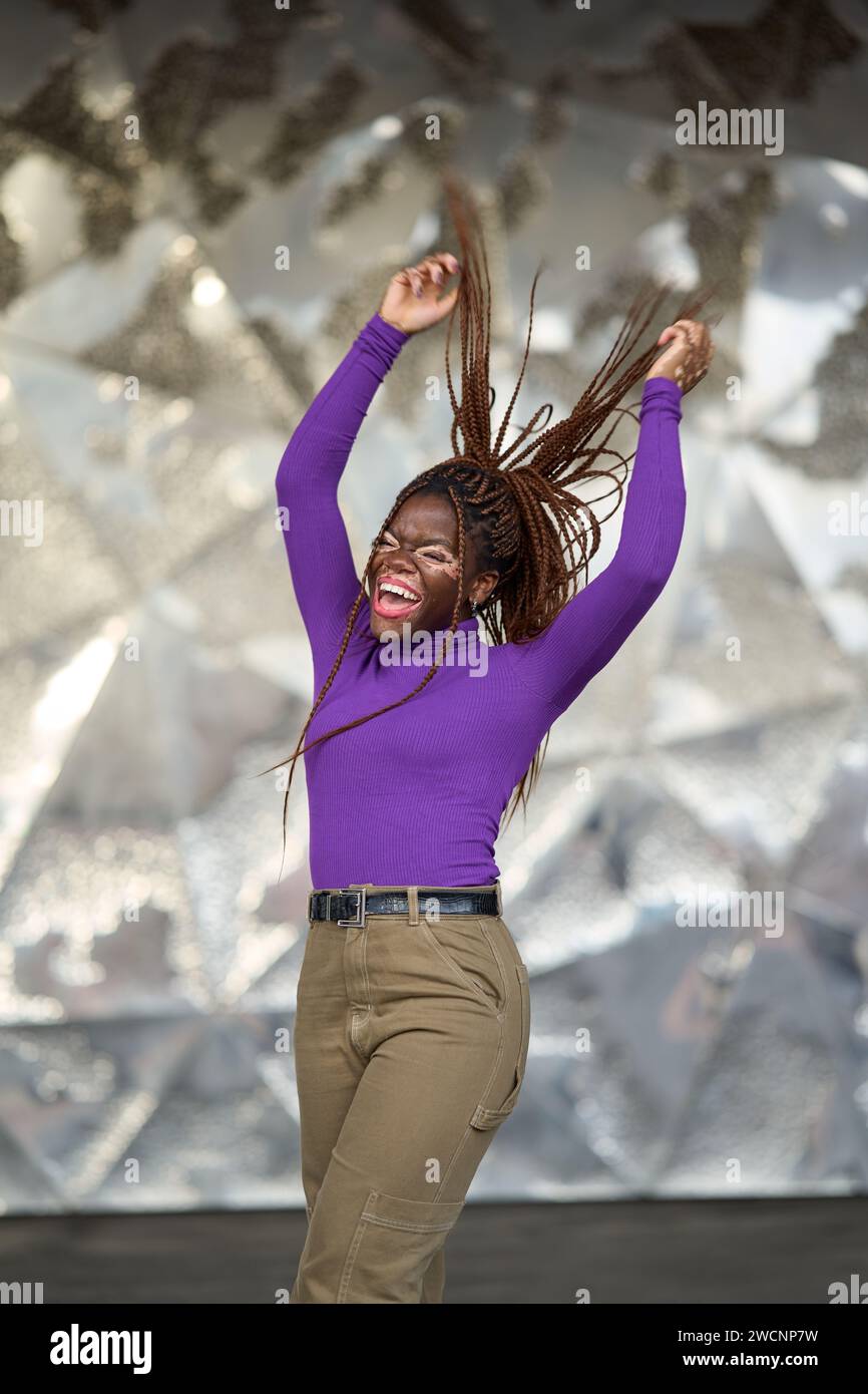 Exuberant Woman Celebrating with Arms Raised Stock Photo - Alamy