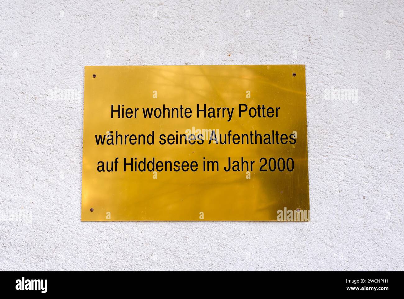 A golden plaque on a wall marking Harry Potter's stay in Hiddensee in ...