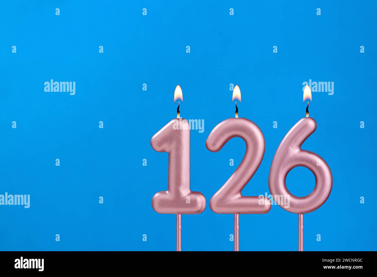 Number 126 - Burning anniversary candle on blue foamy background Stock ...