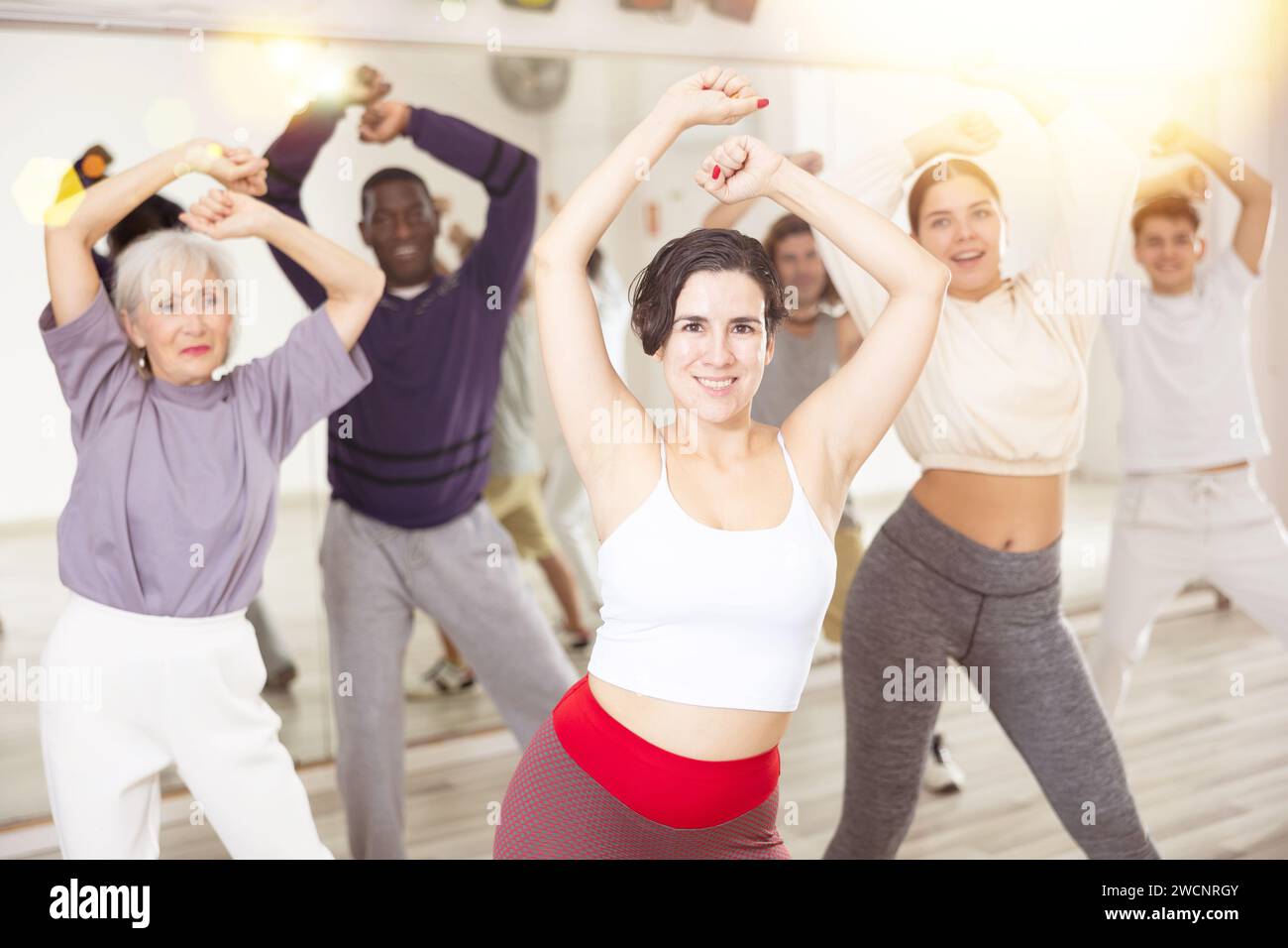 Adult group of people learn the movements of zumba Stock Photo - Alamy