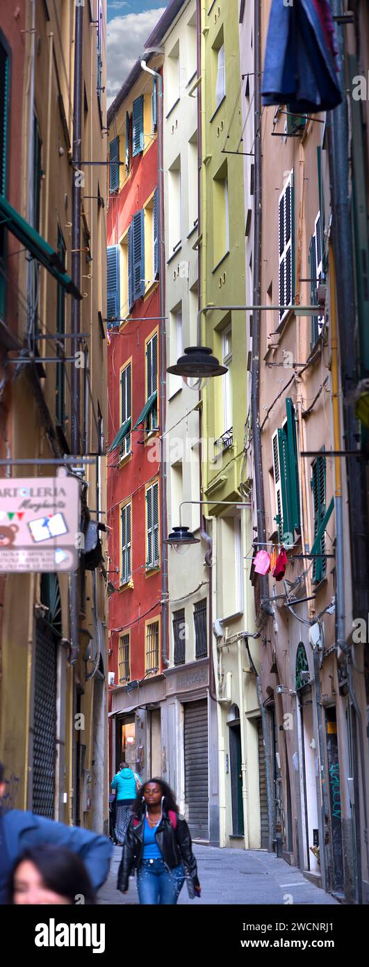 Tall residential buildings in a narrow alley in the historic centre of ...