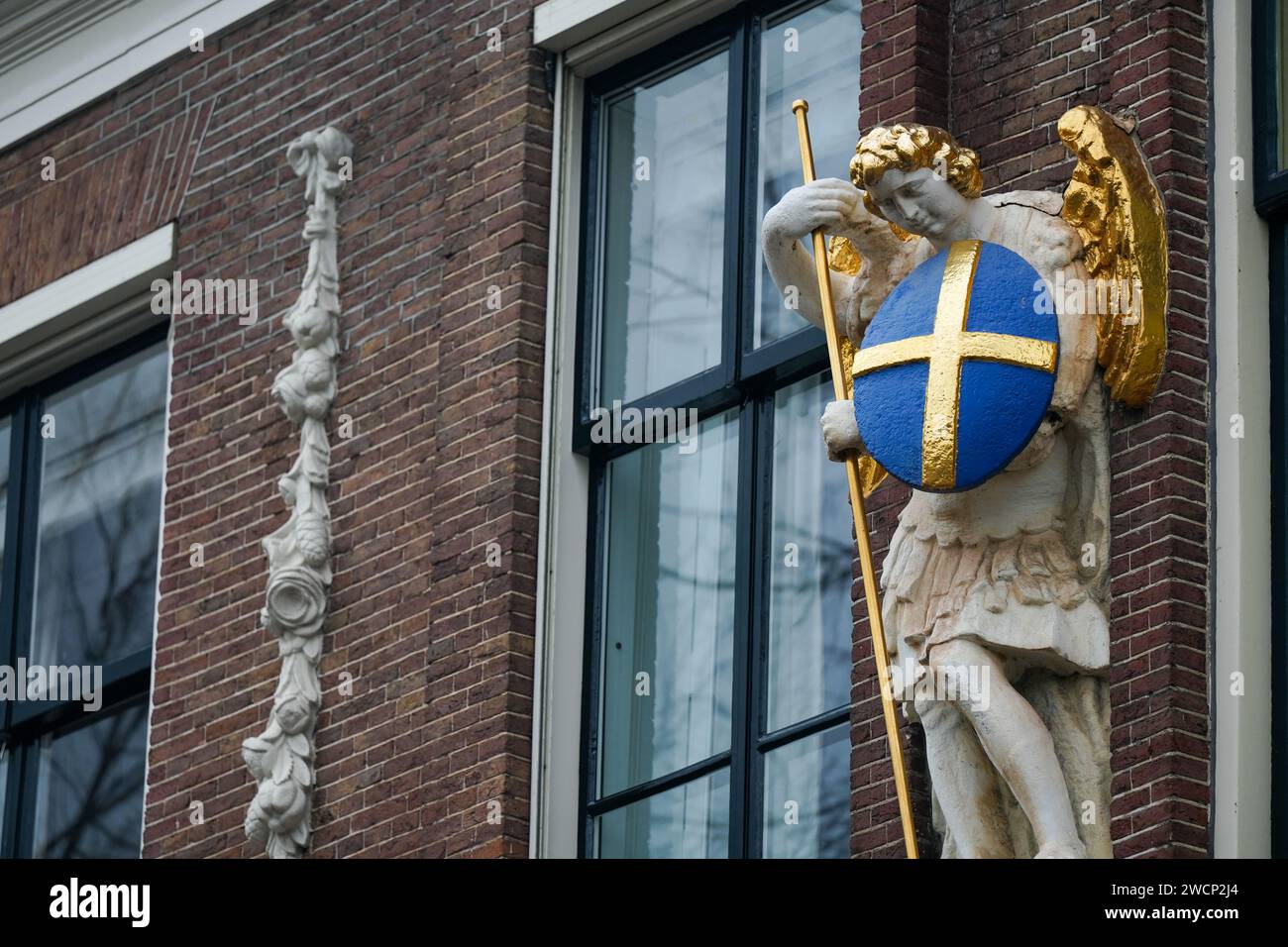 Amsterdam, Netherlands - December 28, 2023: Angel statue with golden ...