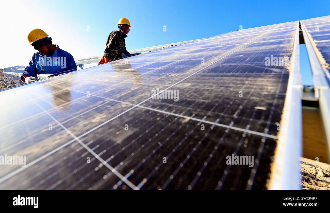 ZHANGYE, CHINA - JANUARY 16, 2024 - Builders work to install photovoltaic panels at the ...