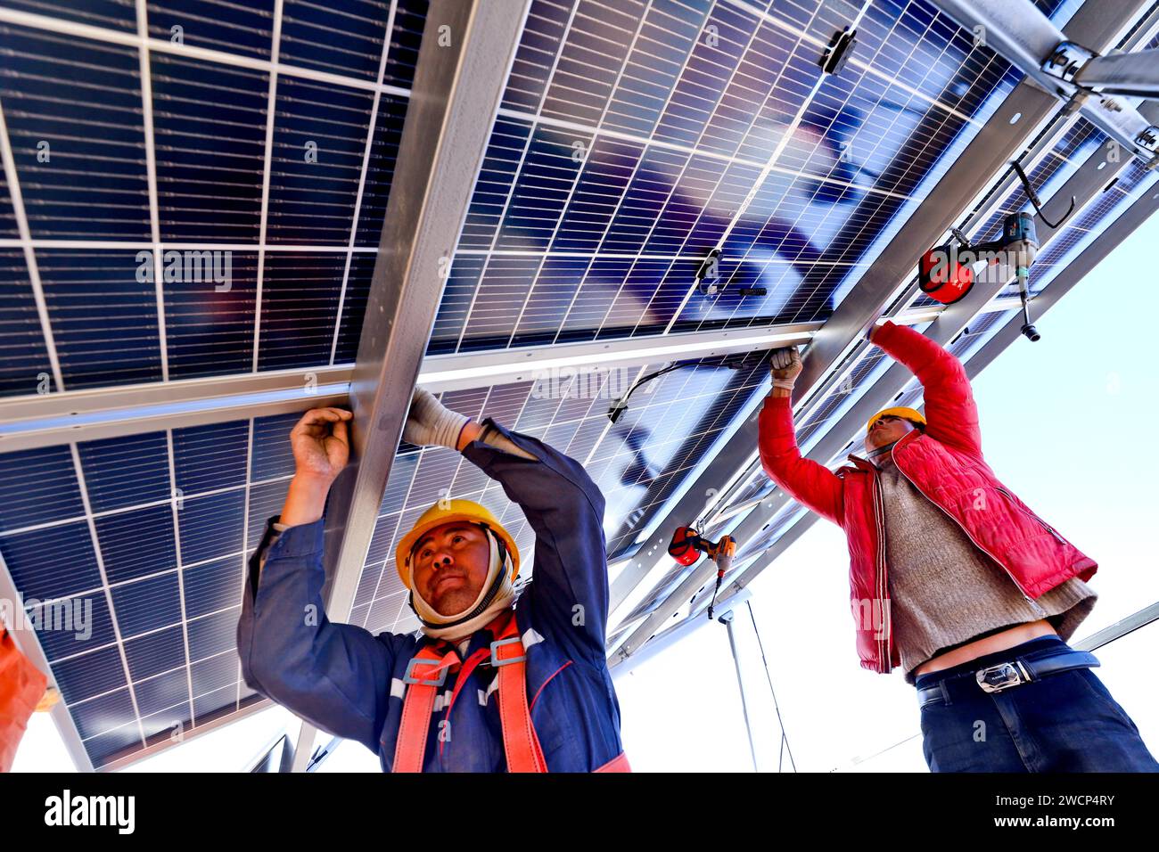 ZHANGYE, CHINA - JANUARY 16, 2024 - Builders work to install photovoltaic panels at the ...