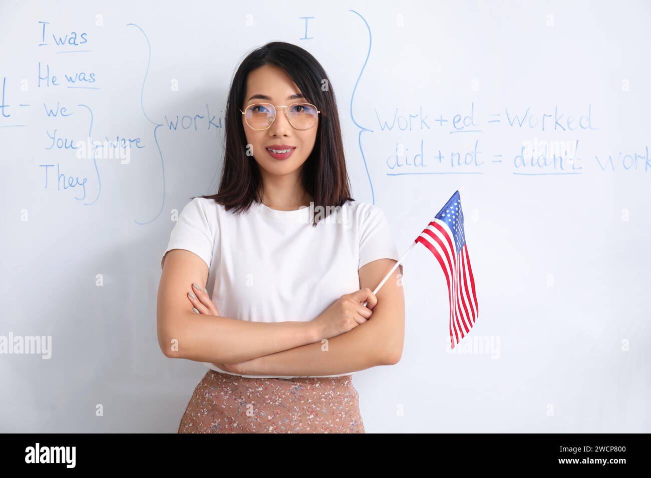 Female English teacher with USA flag conducting grammar lesson in ...