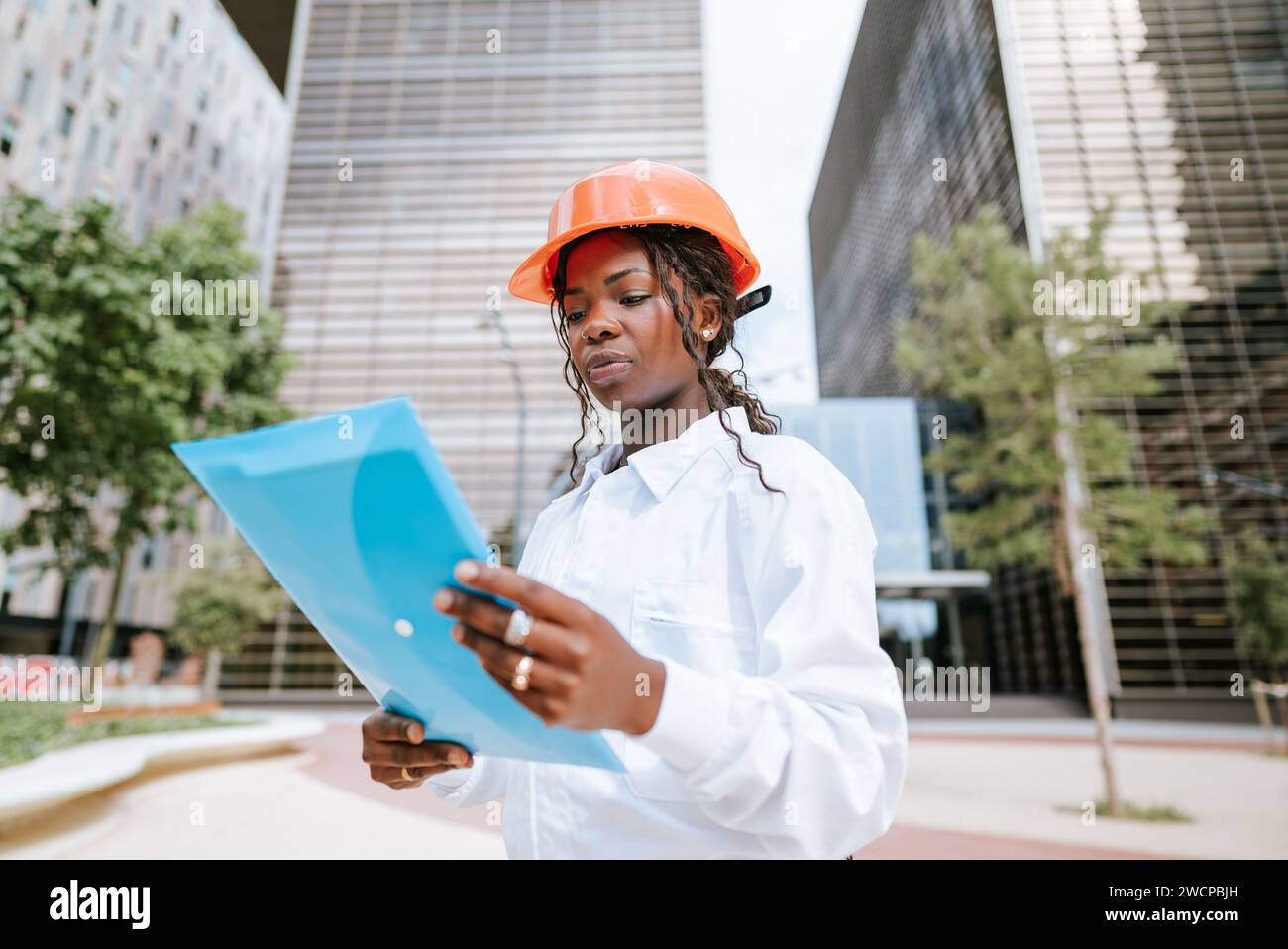 Female engineer reading documents hi-res stock photography and images ...