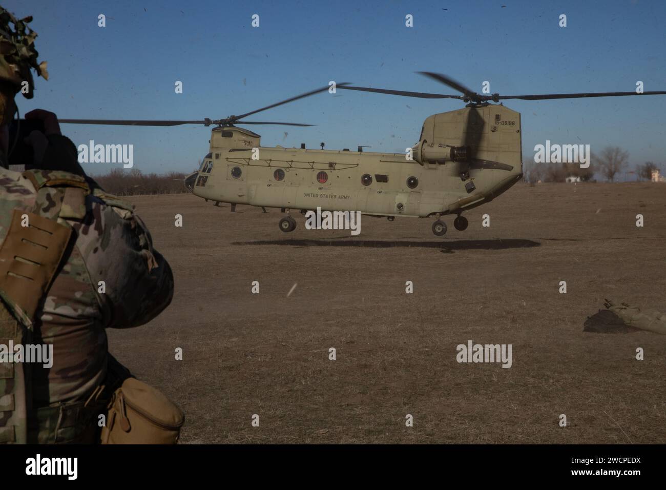 U.S. CH-47 Chinook helicopter lands at landing zone to pick up soldiers ...
