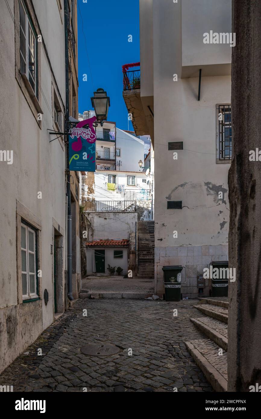 A scenic cobblestone street lined with white buildings and vibrant ...