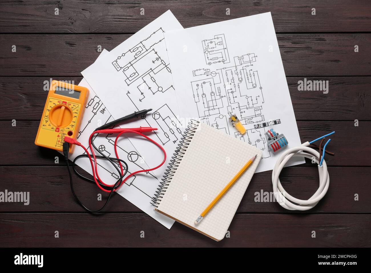 Wiring diagrams, office stationery, wires and digital multimeter on ...