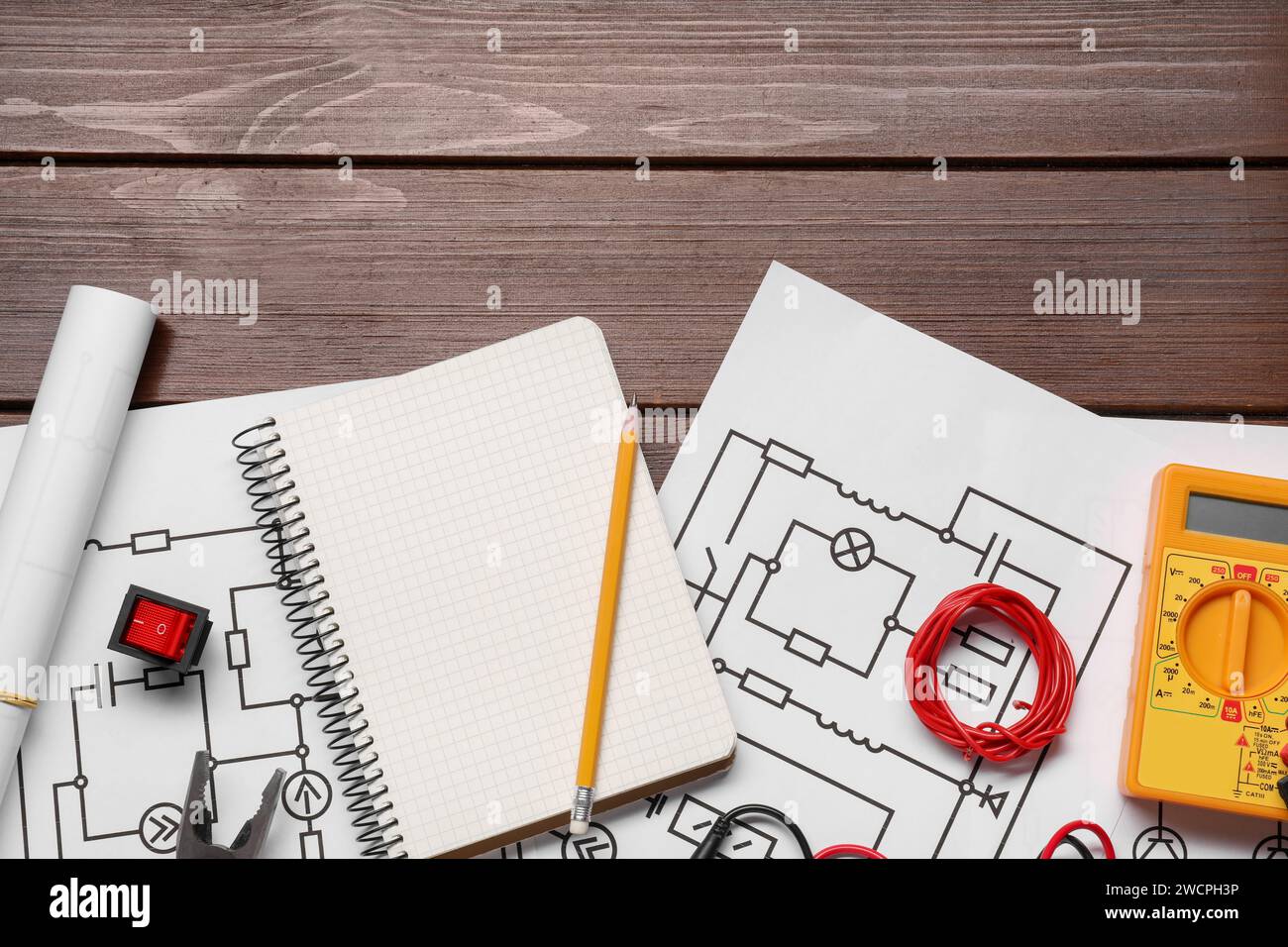 Flat lay composition with wiring diagrams and digital multimeter on ...