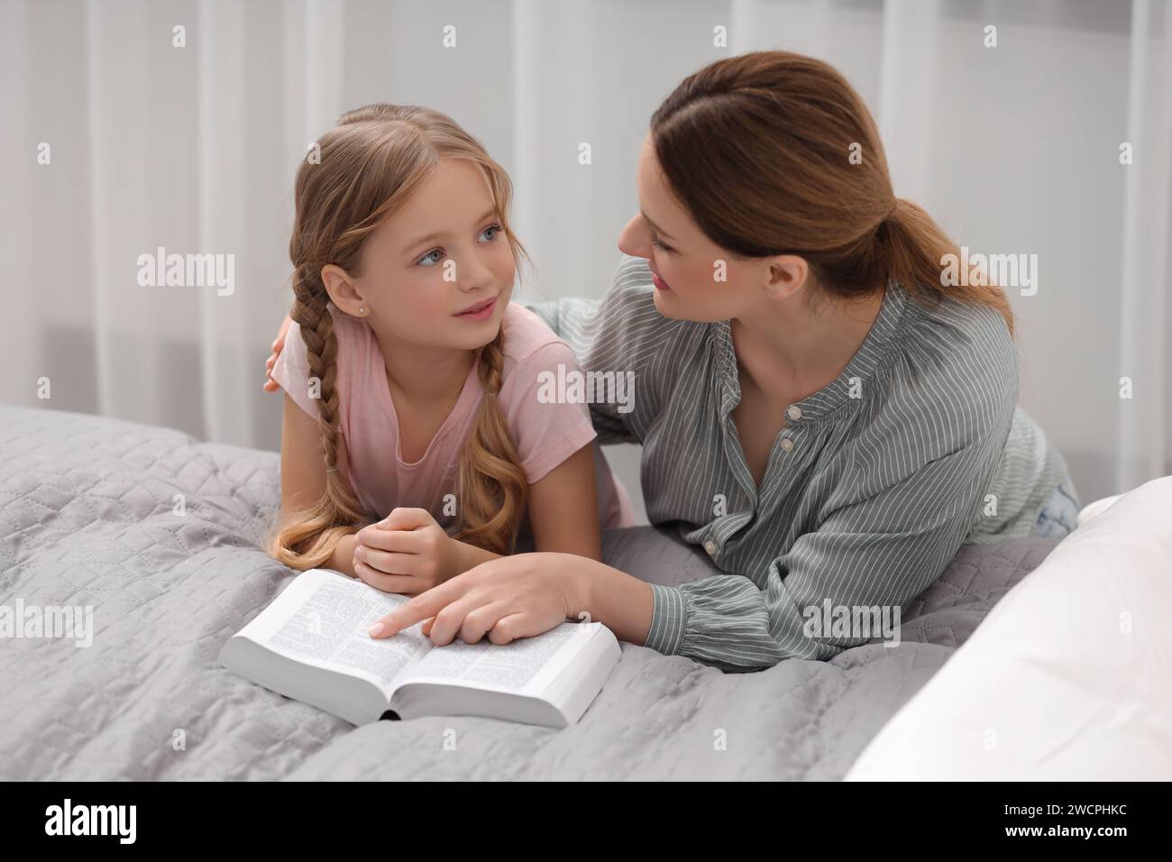Girl reading holy bible home hi-res stock photography and images - Alamy