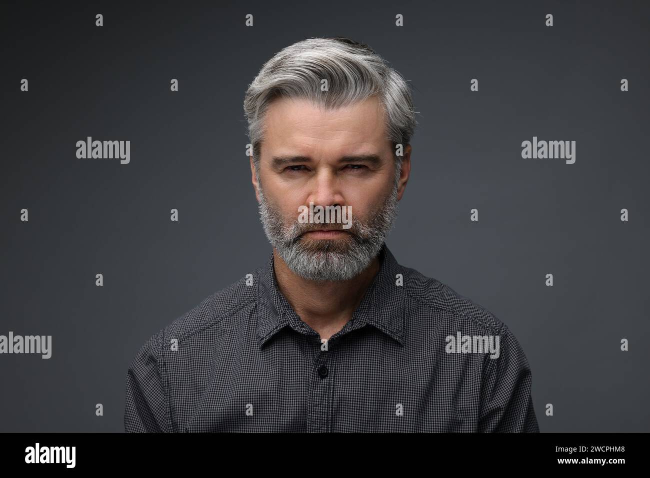 Personality concept. Portrait of emotional man on dark grey background ...