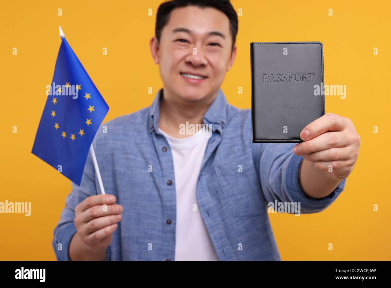 Immigration. Happy man with passport and flag of European Union on ...