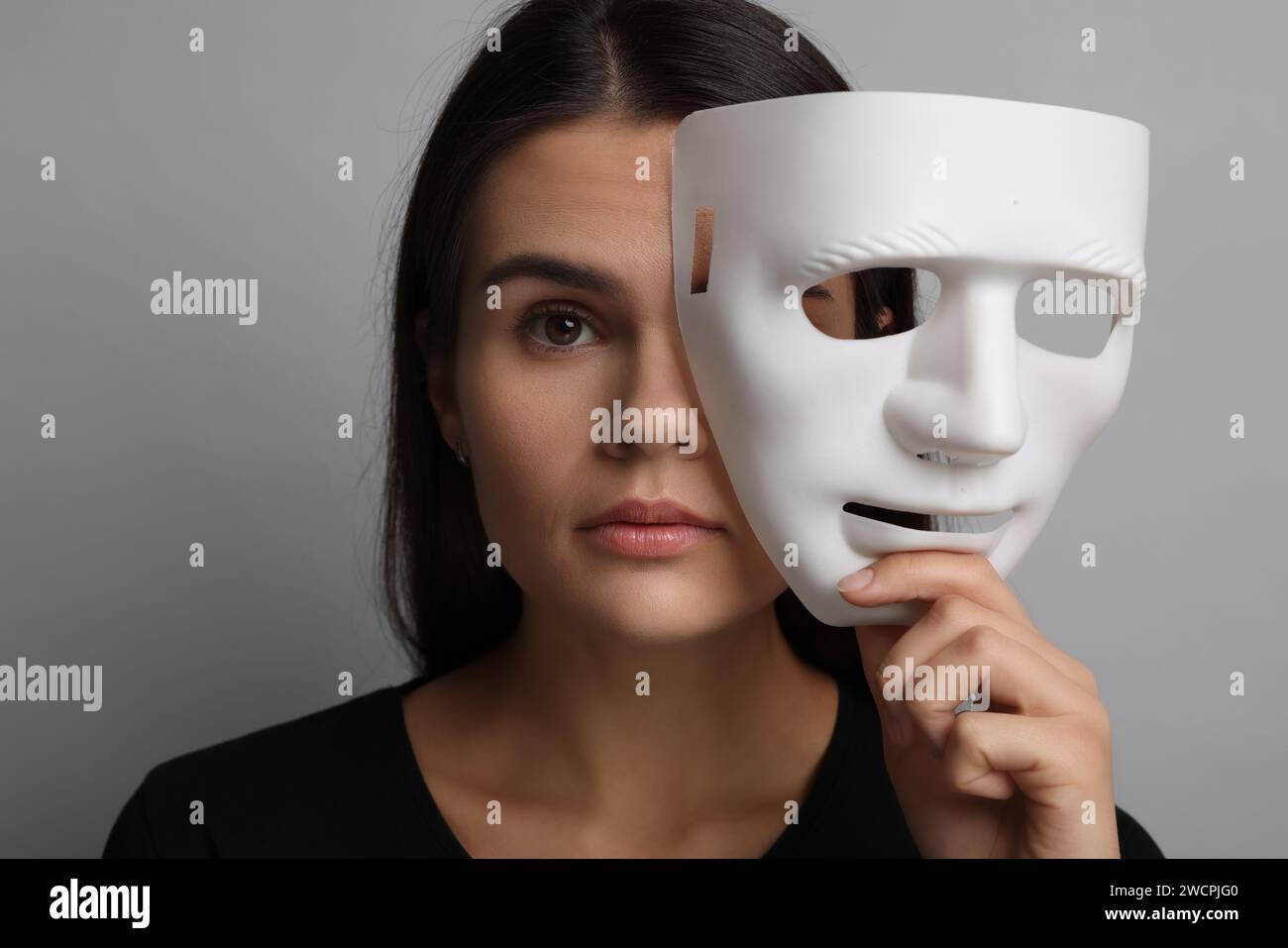 Multiple personality concept. Woman with mask on grey background Stock ... Multiple personality concept. Woman with mask on grey background Stock ...