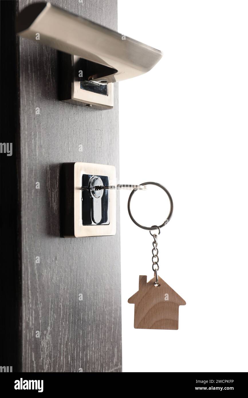 Mortgage and real estate. Open door with key and house shaped keychain ...