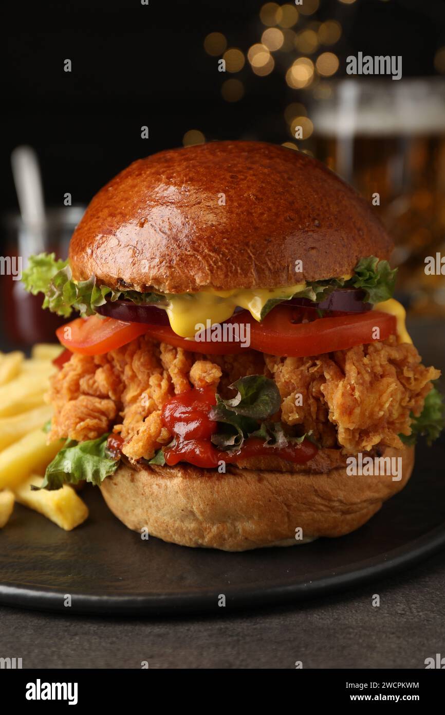 Delicious burger with crispy chicken patty on table, closeup Stock ...