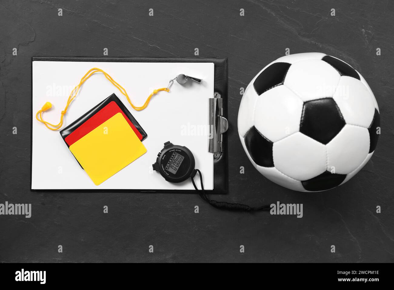 Soccer ball and different referee equipment on black table, top view ...
