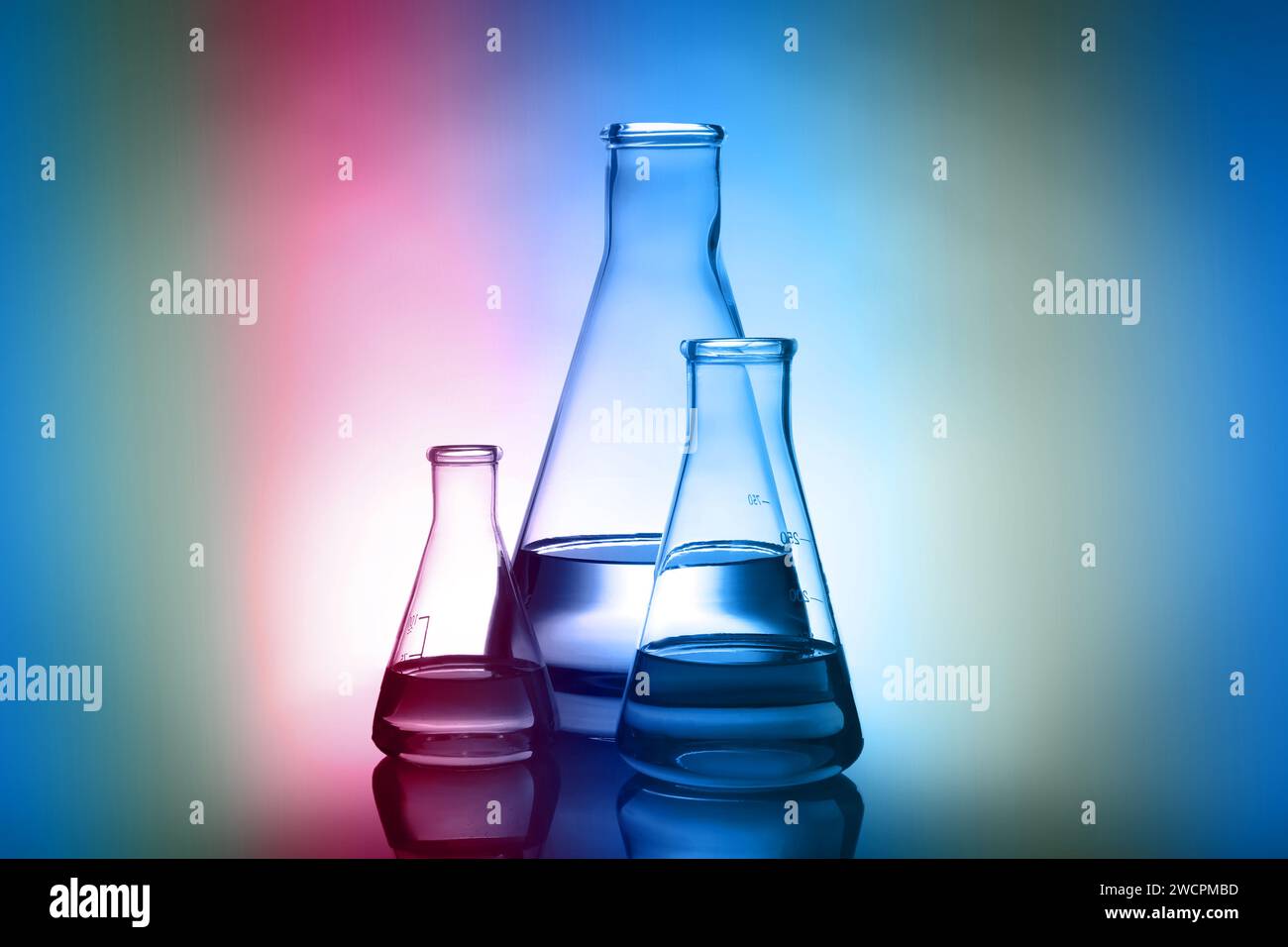 Conical flasks with liquid on table. Color toned Stock Photo - Alamy