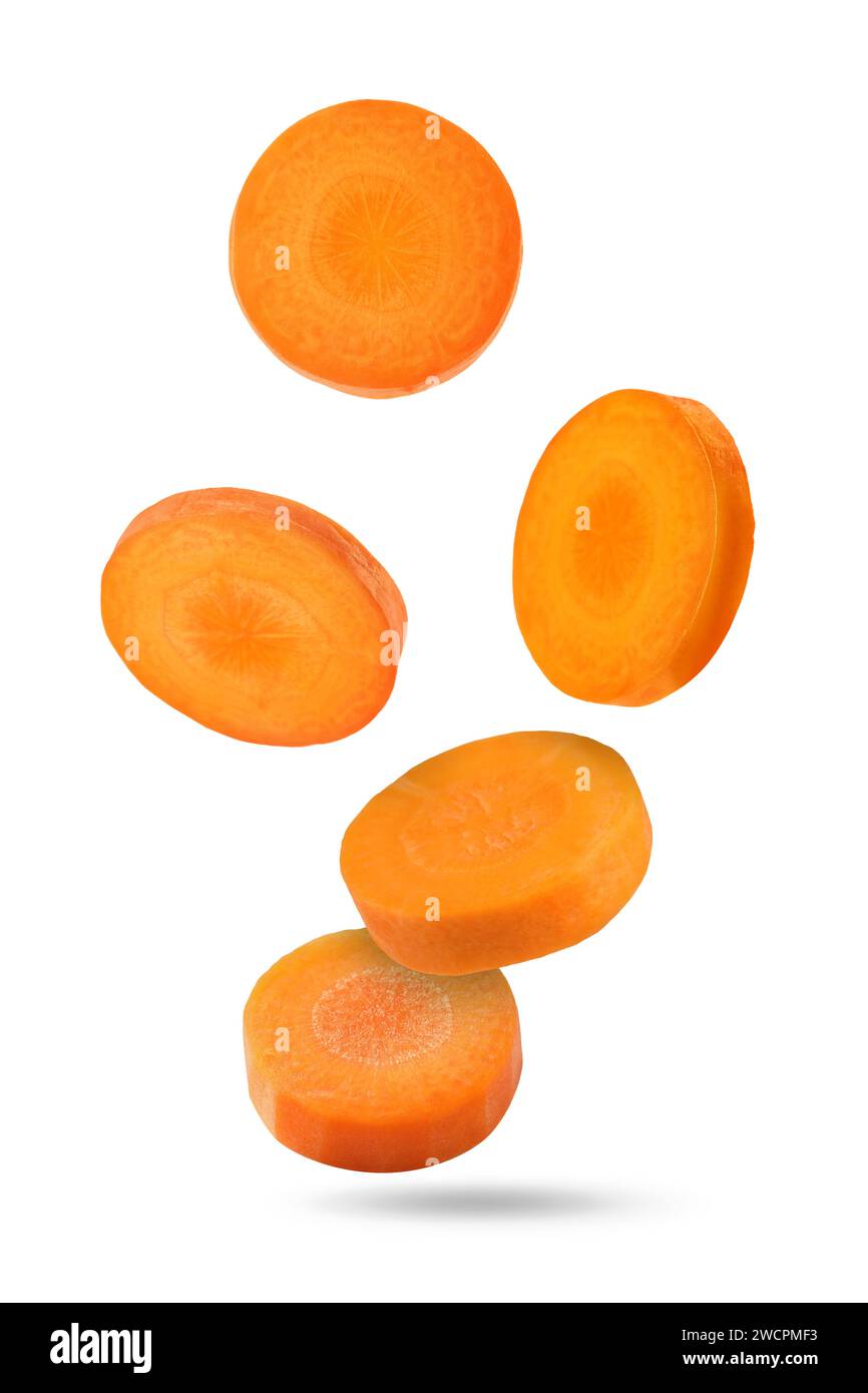 Fresh carrot slices falling on white background Stock Photo - Alamy