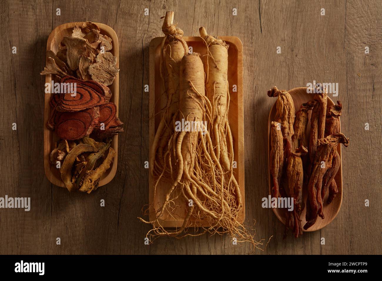 Three wooden plates featured Red ginseng, Ginseng roots and other ...