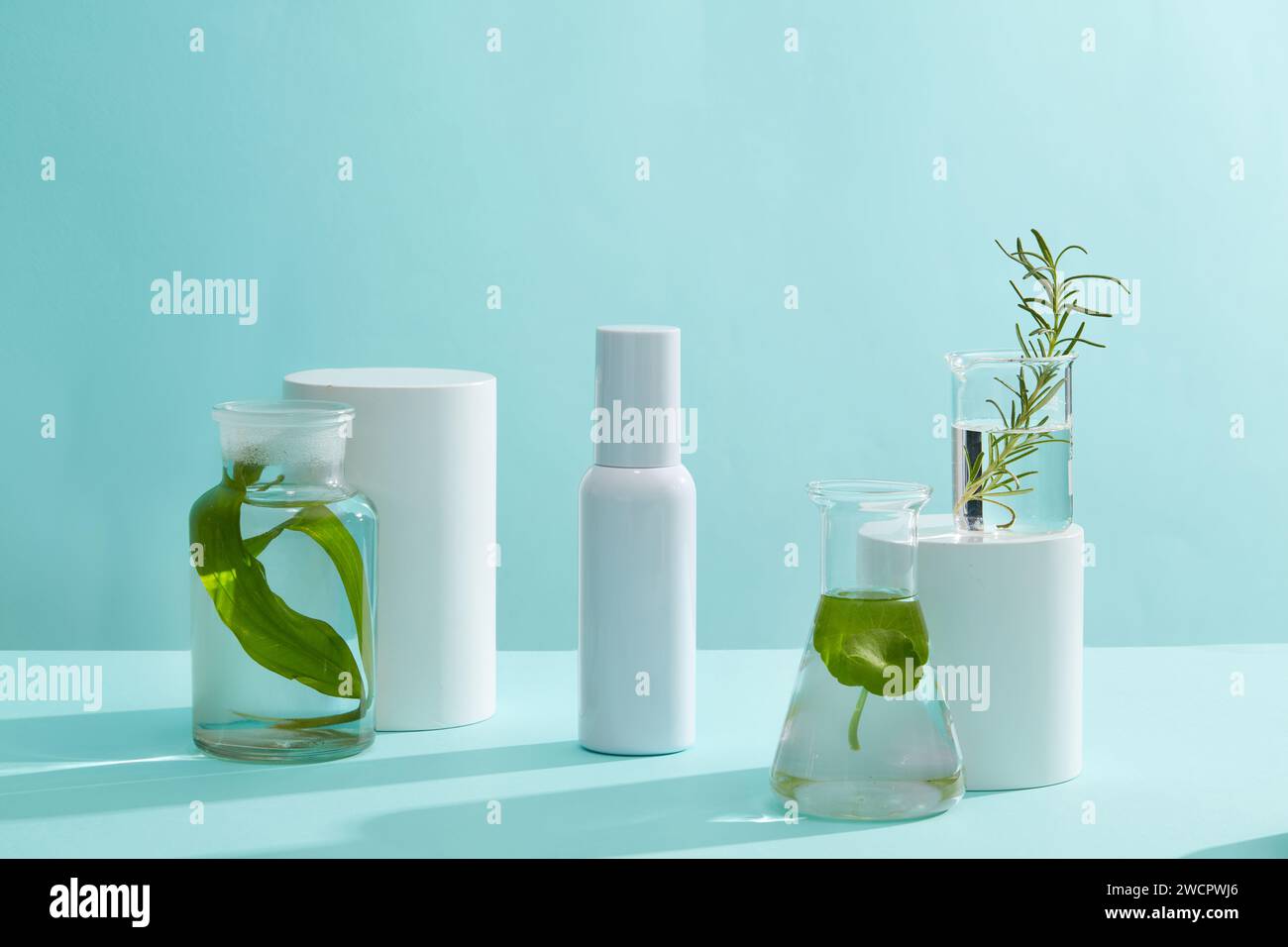 Blue background featured unbranded bottle with a beaker, flask and jar ...