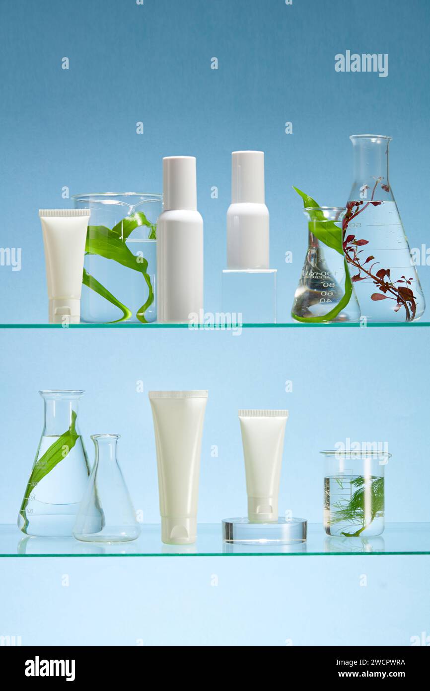 Unbranded tubes and bottles in white color are arranged on shelves with ...