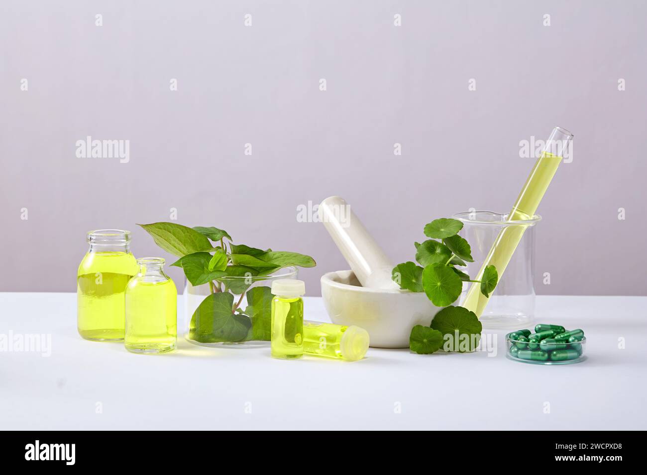 Small bowl of capsules displayed on white background with fresh fish ...