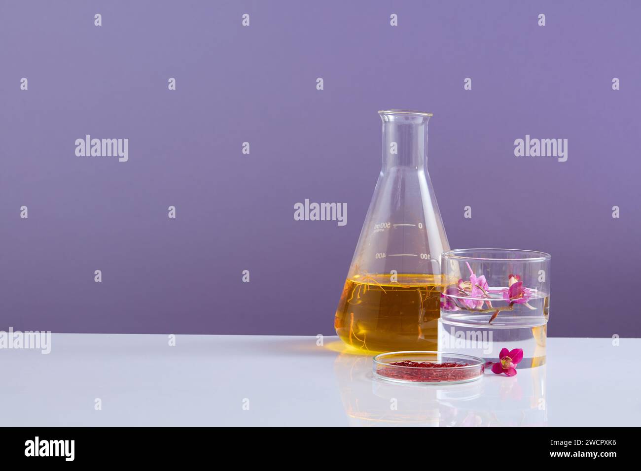 An erlenmeyer flask of yellow fluid displayed with a jar of purple ...