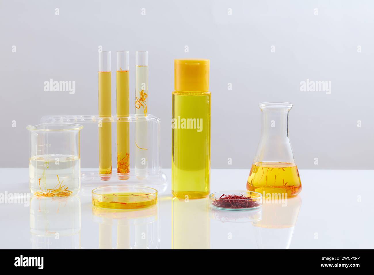 Unbranded bottle filled with liquid and arranged with laboratory ...