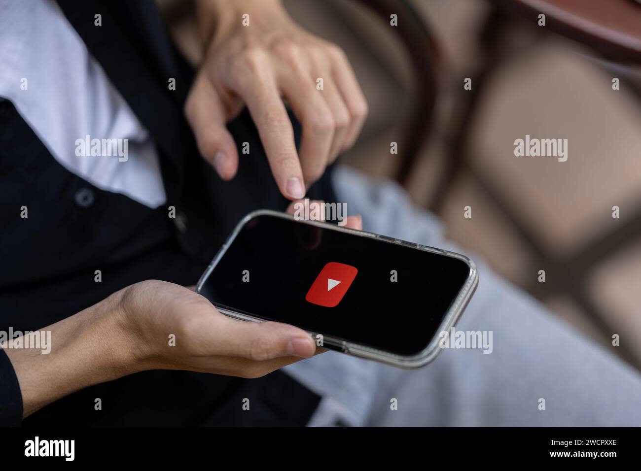 Chiang mai, Thailand - Jan 16 2024: A man using Youtube application on ...