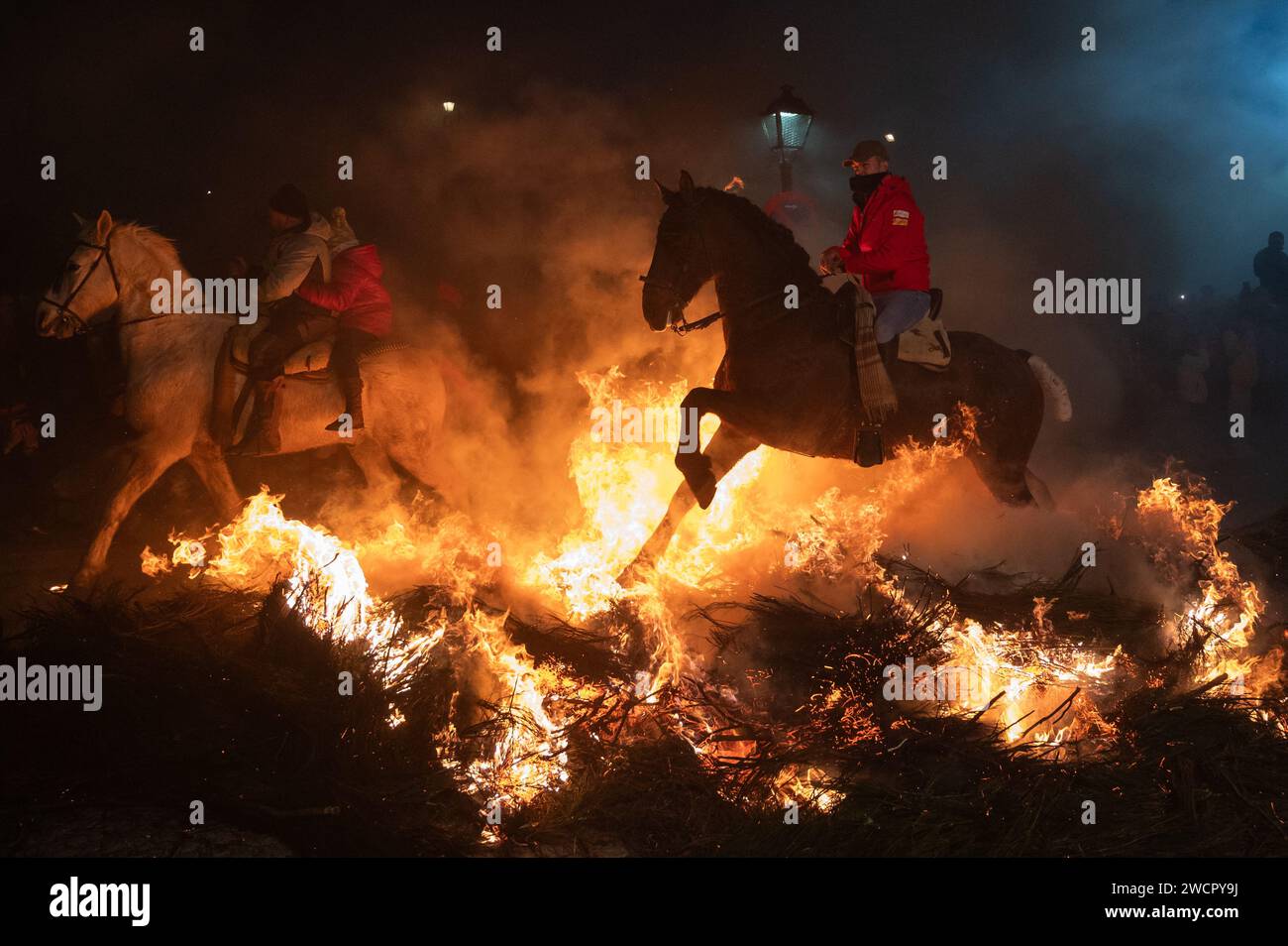 San Bartolome De Pinares, Spain. 16th Jan, 2024. Horse riders jump over ...