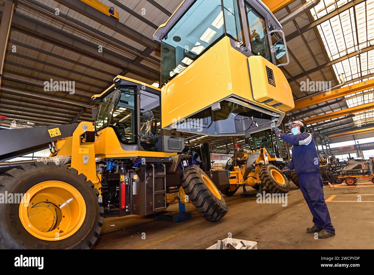 QINGZHOU, CHINA - JANUARY 17, 2024 - A worker lifts a loader at a ...