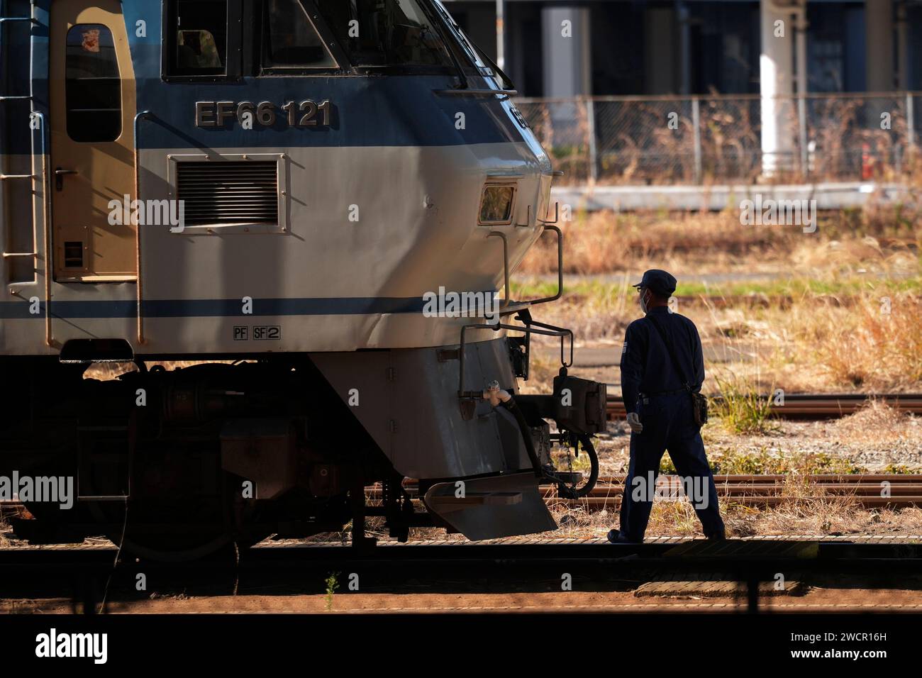 A railroad crew member walks by a train at a locomotive depot Wednesday ...