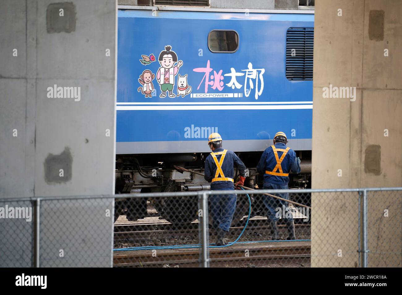 Railroad crew members wash a train at a locomotive depot Wednesday, Jan ...