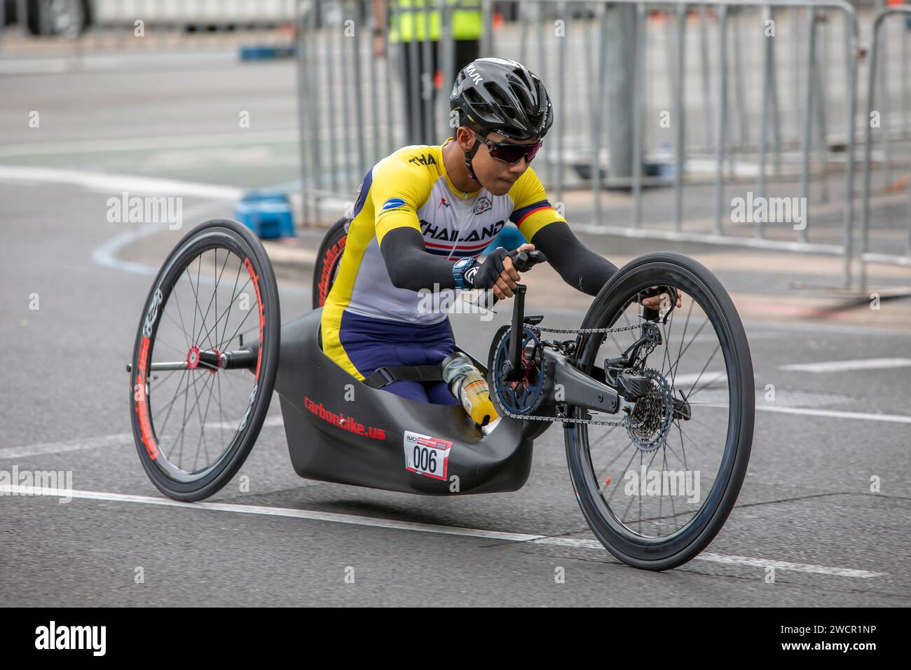 A kneeling Para Cyclist riding a handcycle races along Pulteney Street ...
