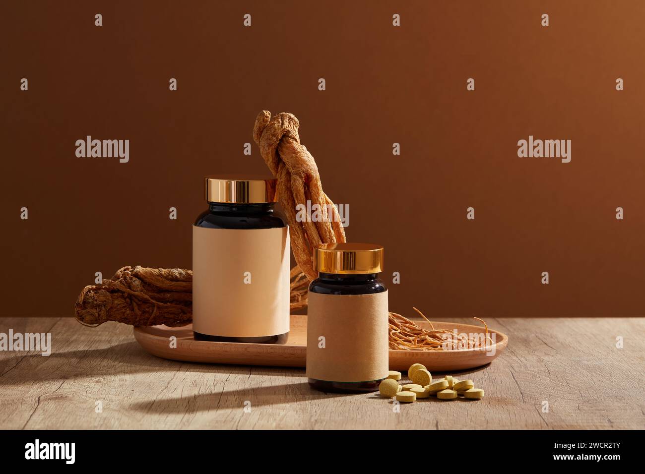 Two unlabeled glass jars decorated with a wooden tray of Angelica root ...